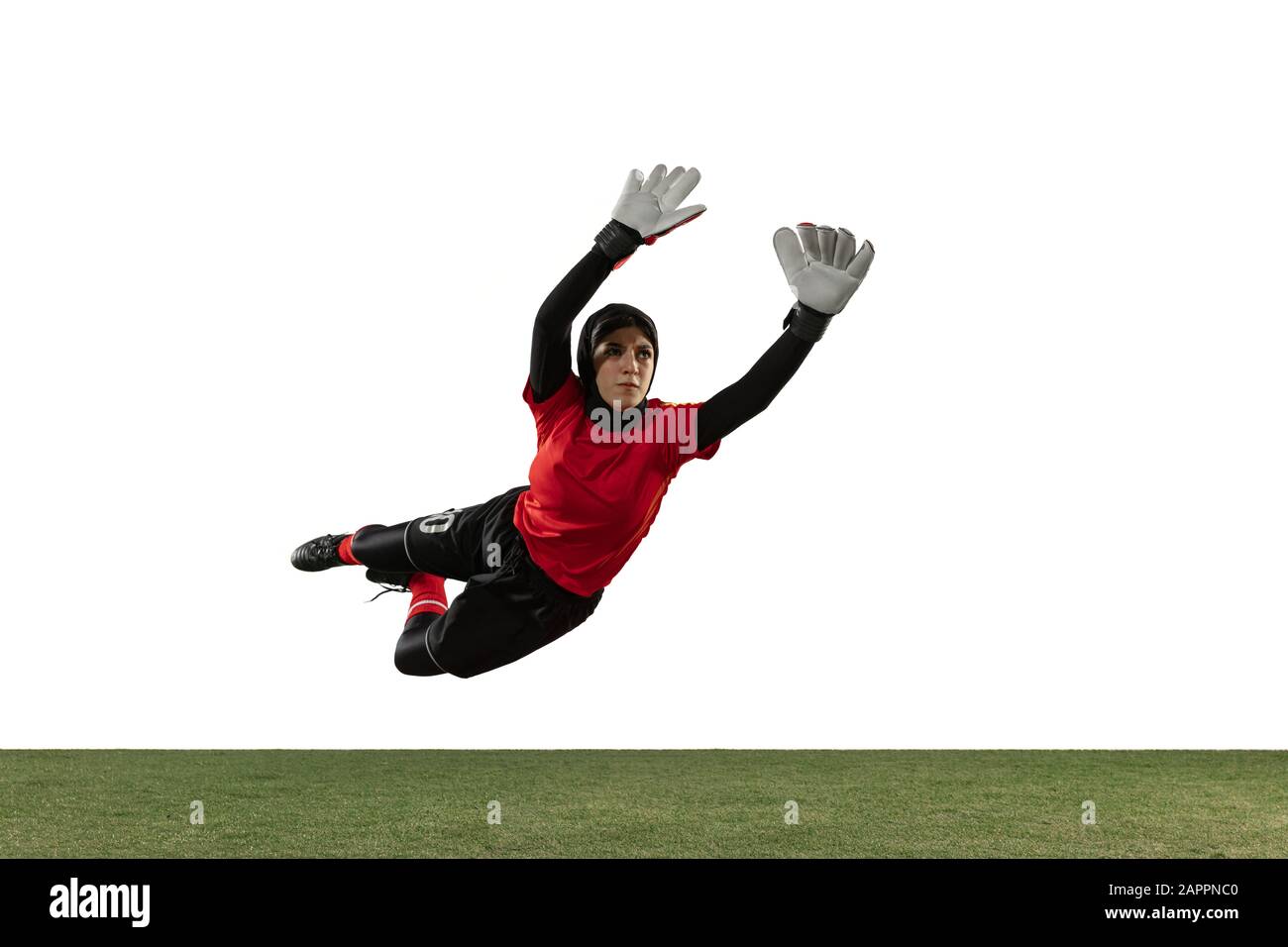 Arabian female soccer or football player, goalkeeper on white studio ...