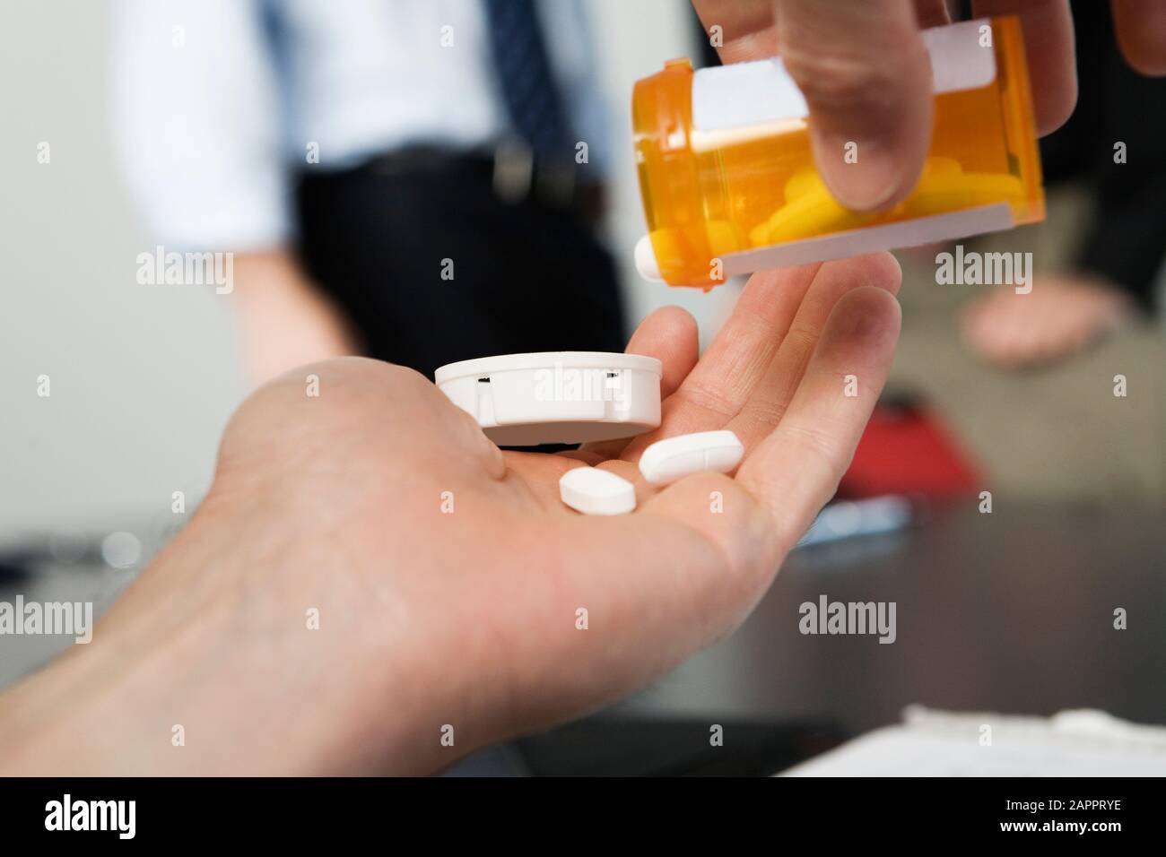 View of a businessman taking drugs in the office Stock Photo - Alamy