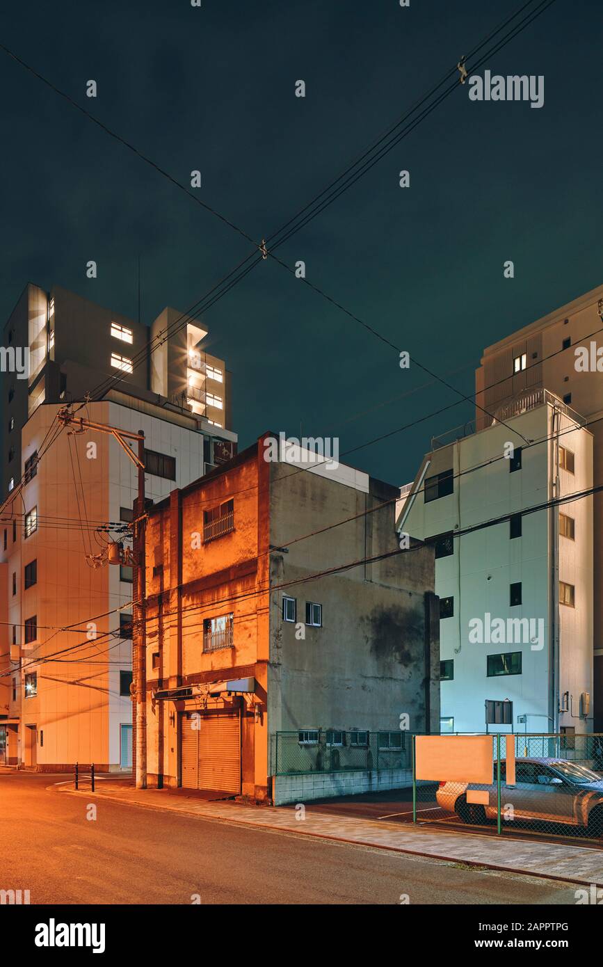 Night scene of old apartment block buildings, Osaka, Japan Stock Photo ...