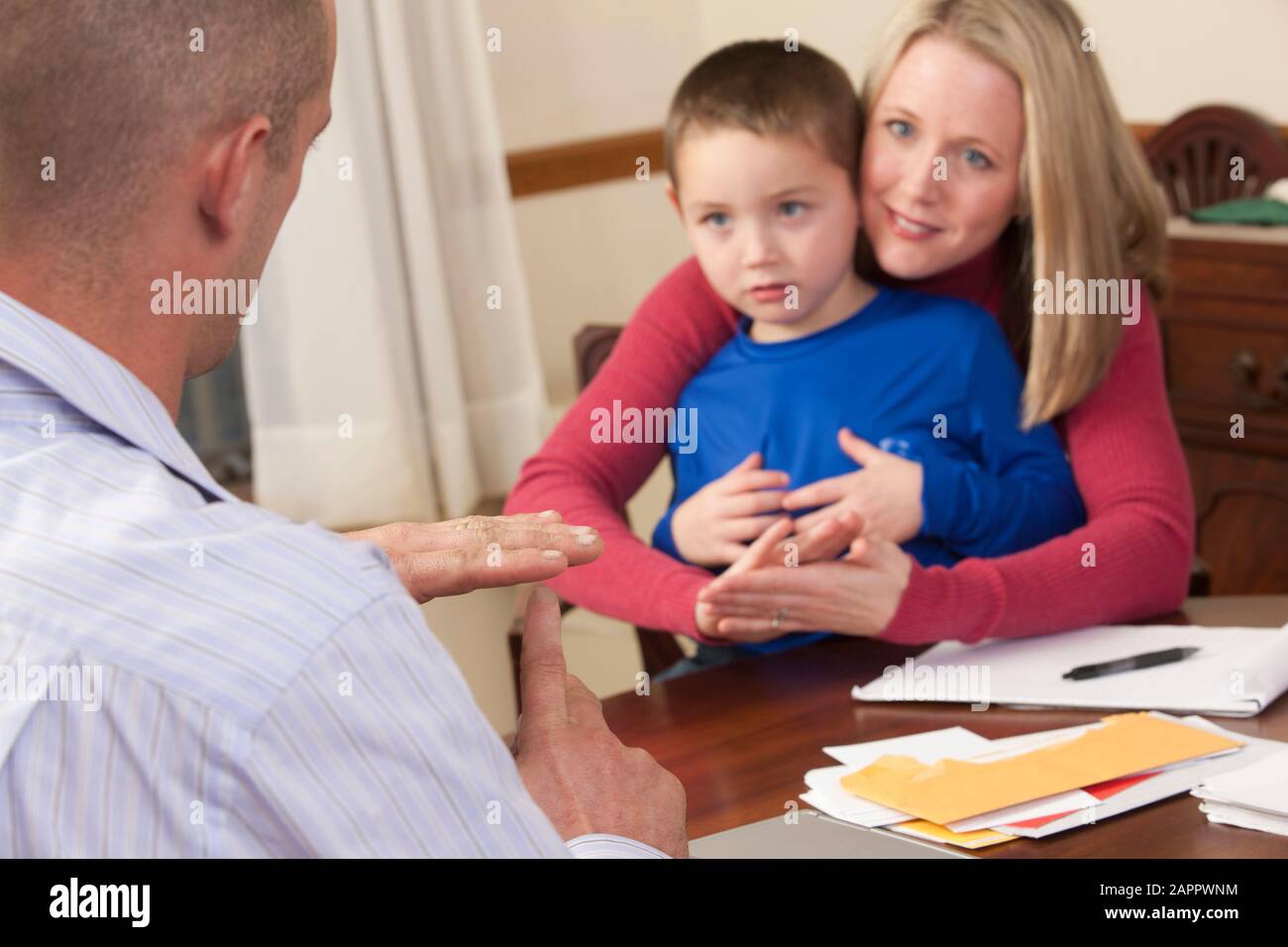 Parents teaching a child to use sign language Stock Photo - Alamy