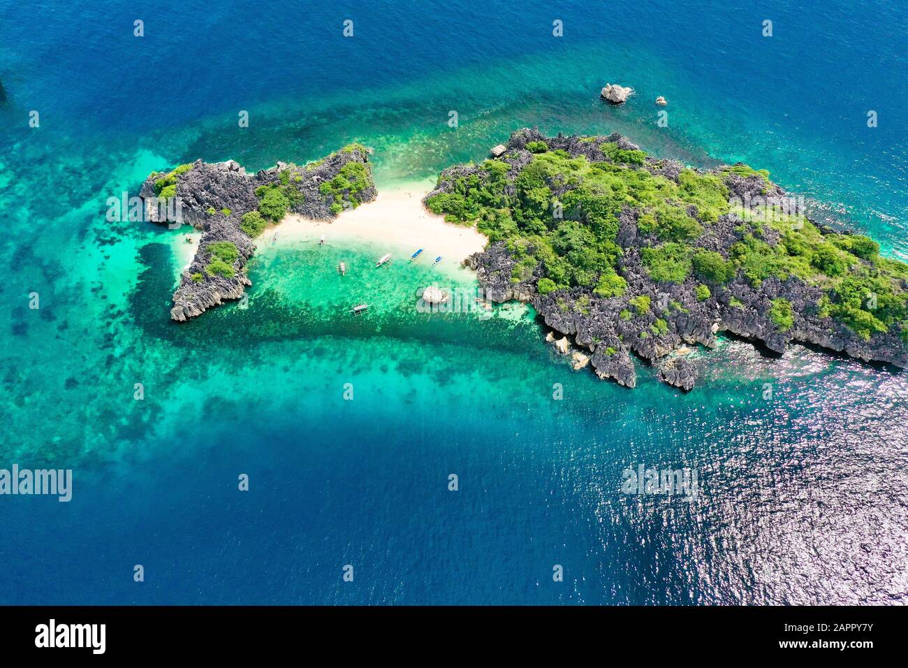 Aerial view of small isolated tropical island with white sandy beach ...