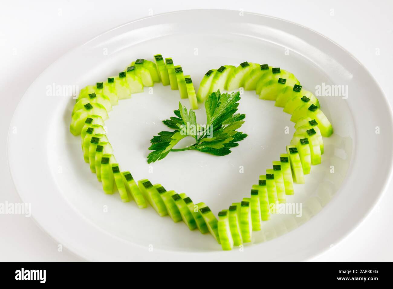 Cut sliced peeled cucumber in heart shape.Selective focus with shallow ...