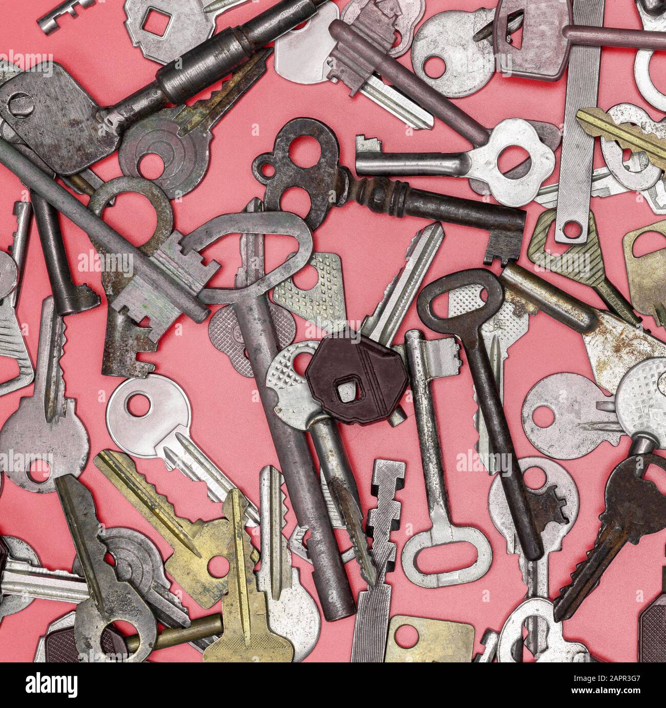 Keys set on pink background. Door lock keys and safes for property ...