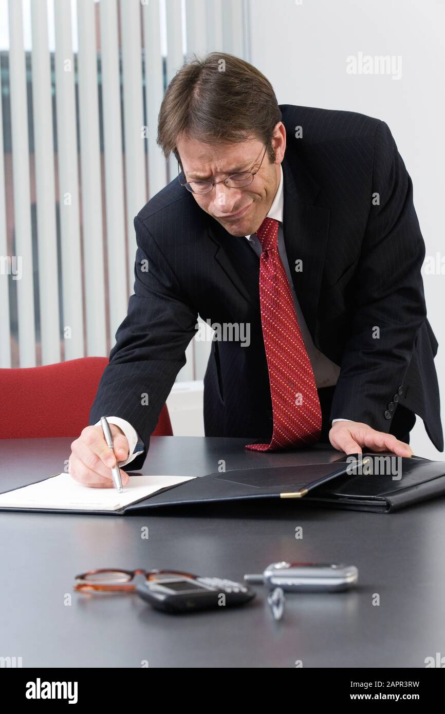 Business man signing a document Stock Photo - Alamy