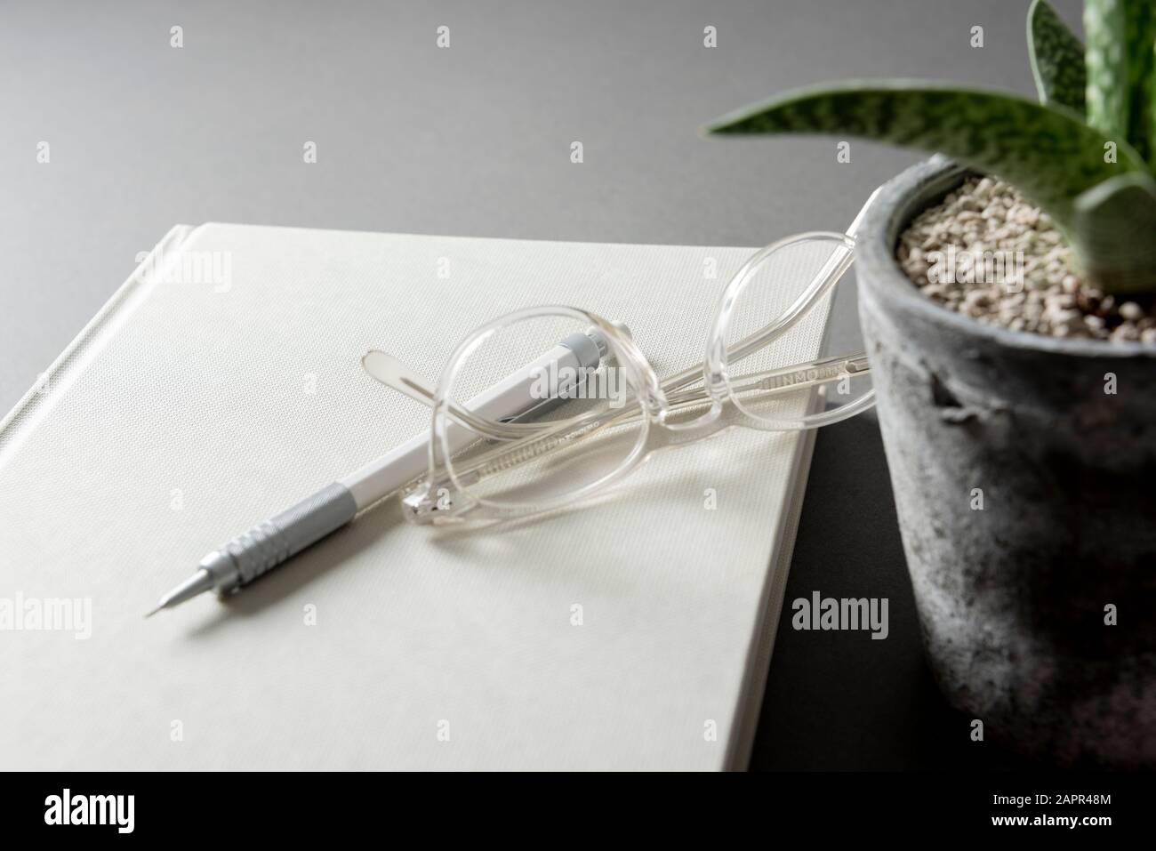 White diary on a grey desk Stock Photo - Alamy