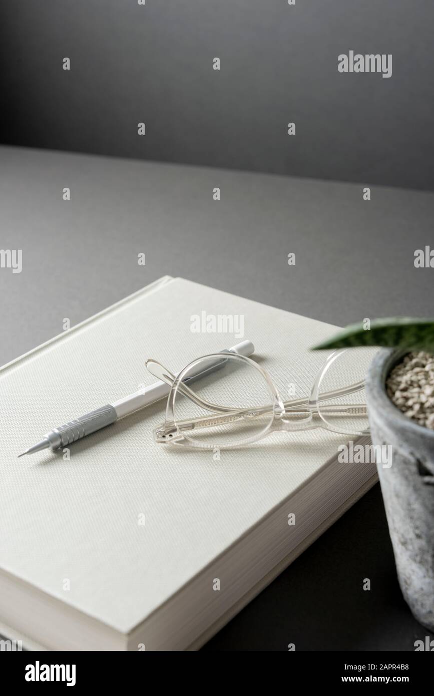 White diary on a grey desk Stock Photo - Alamy