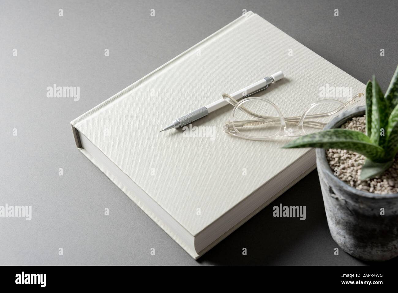 White diary on a grey desk Stock Photo - Alamy