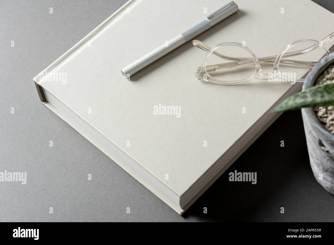 White diary on a grey desk Stock Photo - Alamy
