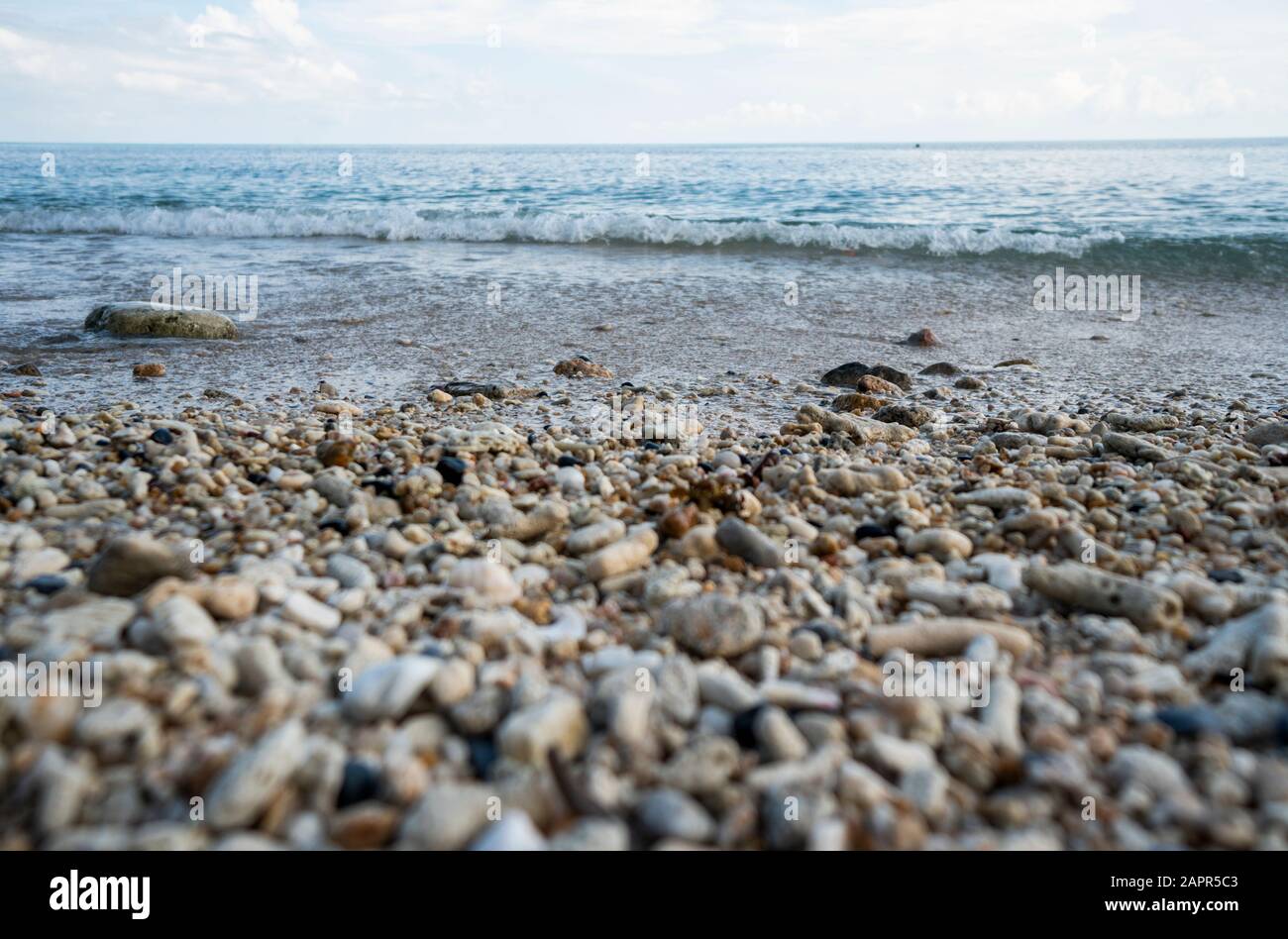 Close up of rounded and polished beach rocks. Pebble stones at the sea ...