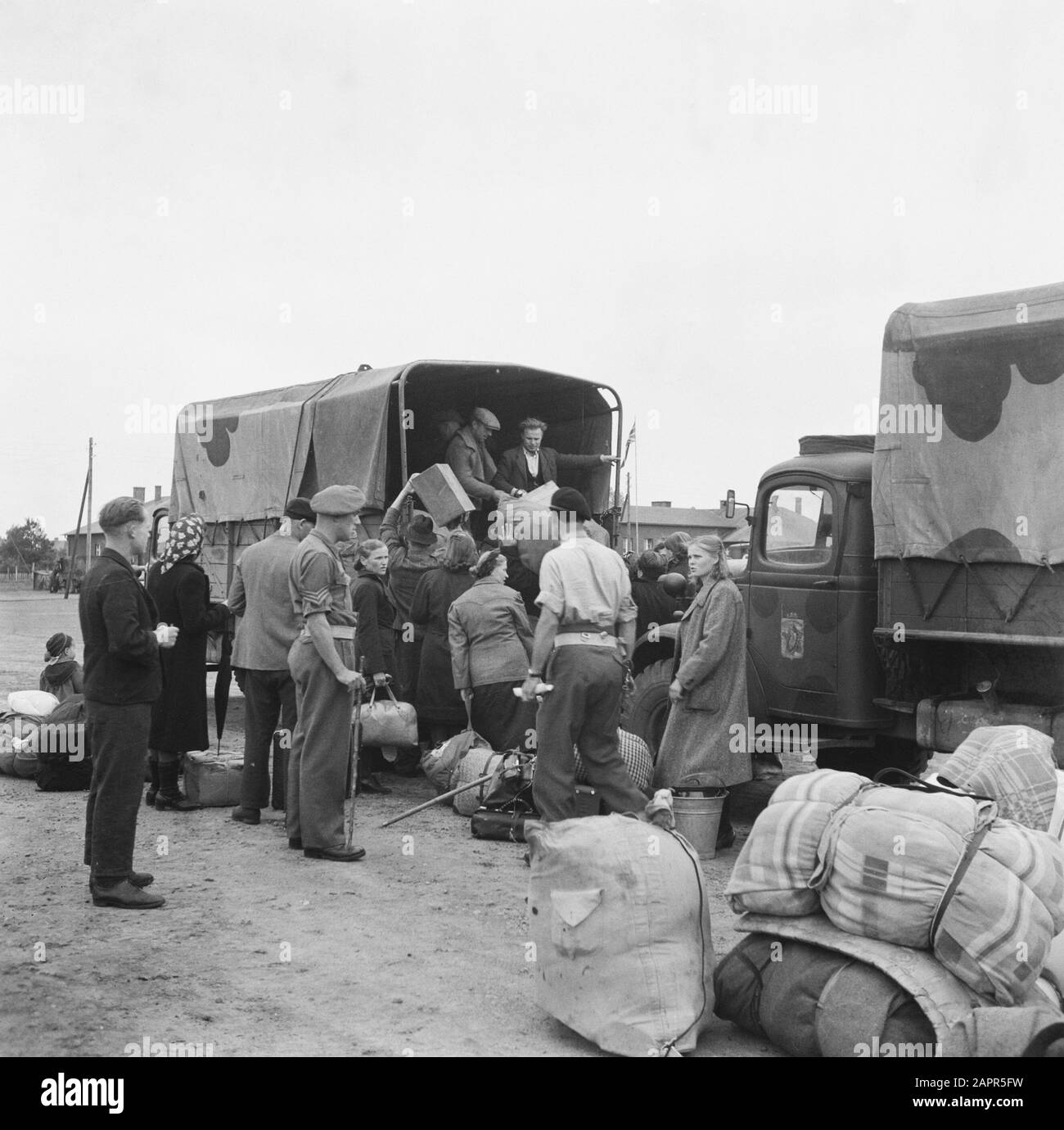 Repatriation Camp Rheine (Germany) [Repatriants with luggage at trucks ...
