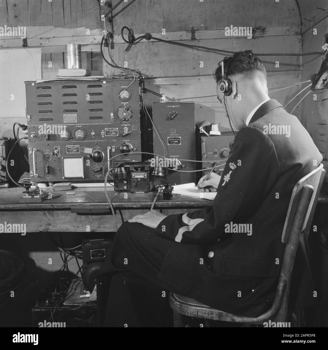 Recovery: Schiphol Uniformed man behind radio equipment Date: 1945 ...