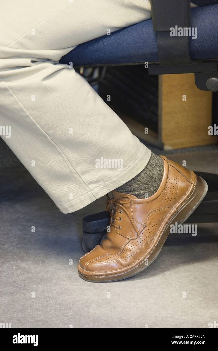 Low section view of a man sitting on a chair Stock Photo - Alamy