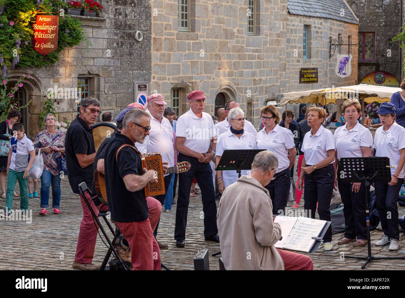 Locronan village square; group of traditional celtic singers gather in ...