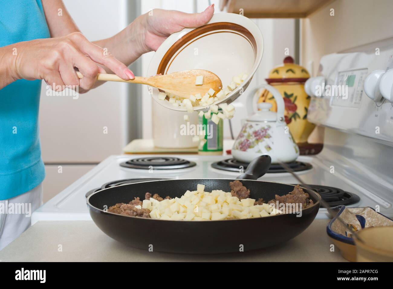 Mid section view of a woman cooking in the kitchen Stock Photo - Alamy