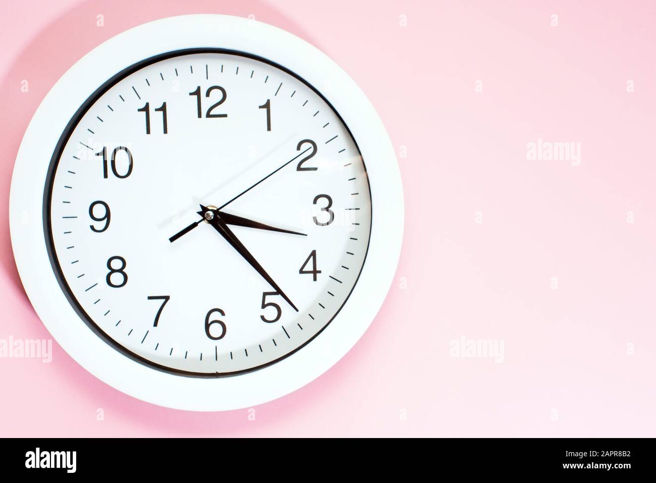 Minimal concept, Office wall clock floating on a pink background. with ...
