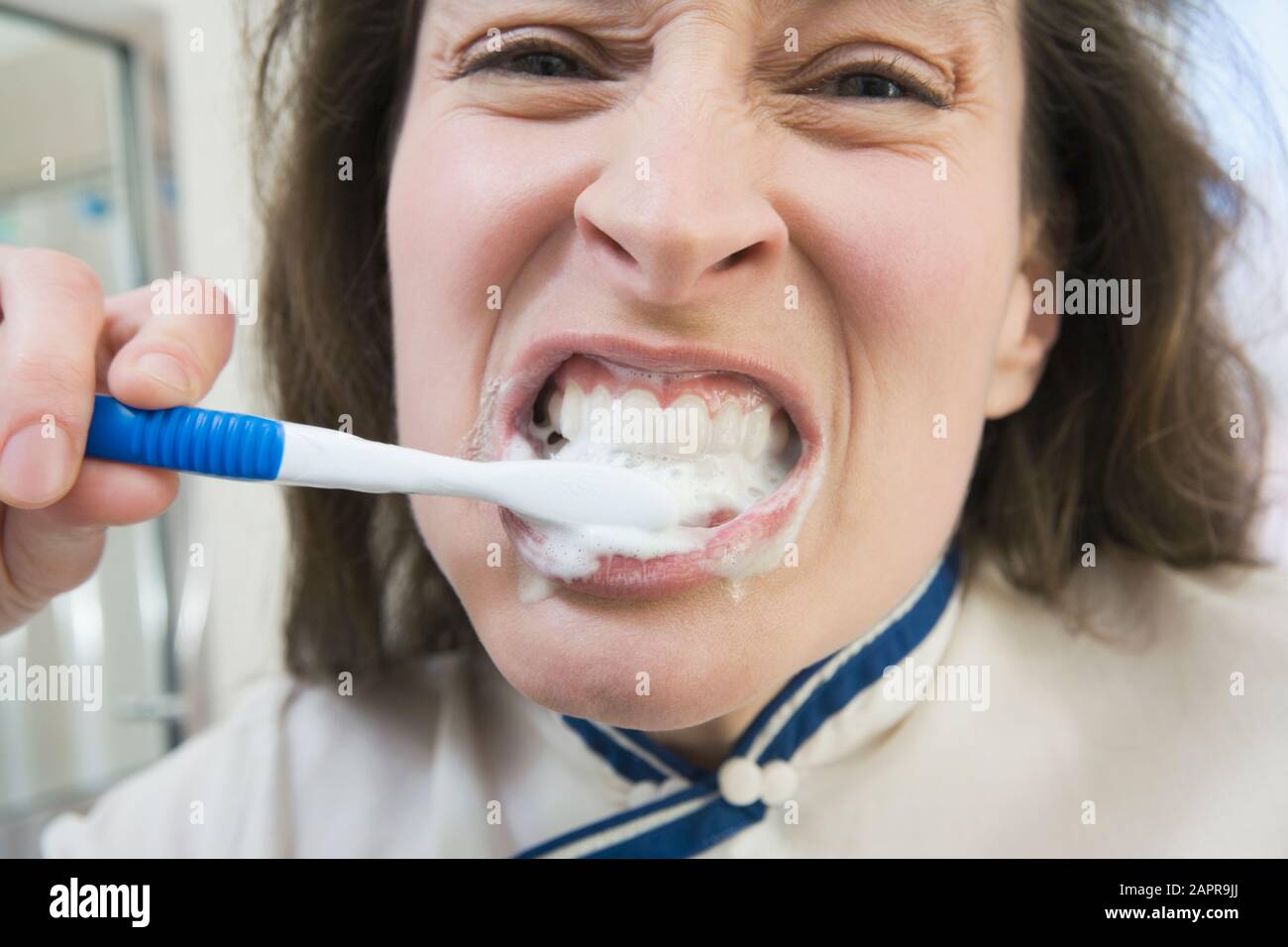 Portrait of a mid adult woman brushing her teeth Stock Photo - Alamy
