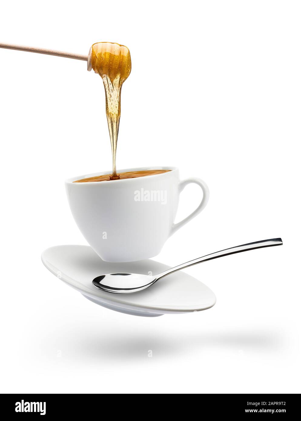 Honey dripping into cup of tea, on white background Stock Photo - Alamy