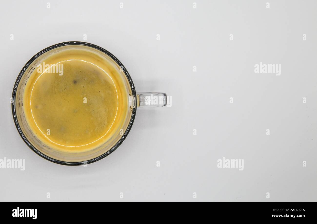Top view close up on isolated transparent glass cup with coffee, white ...