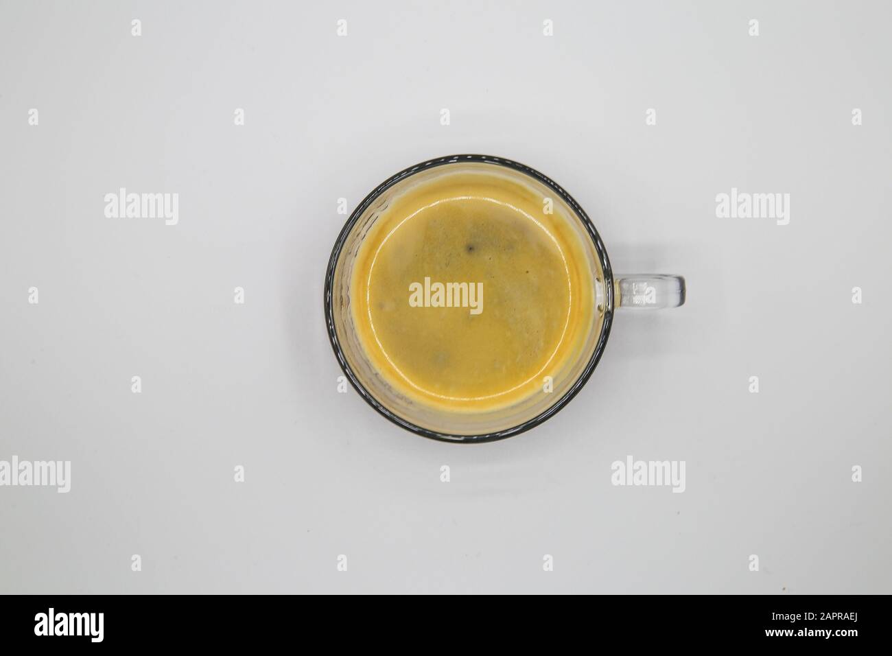 Top view close up on isolated transparent glass cup with coffee, white ...