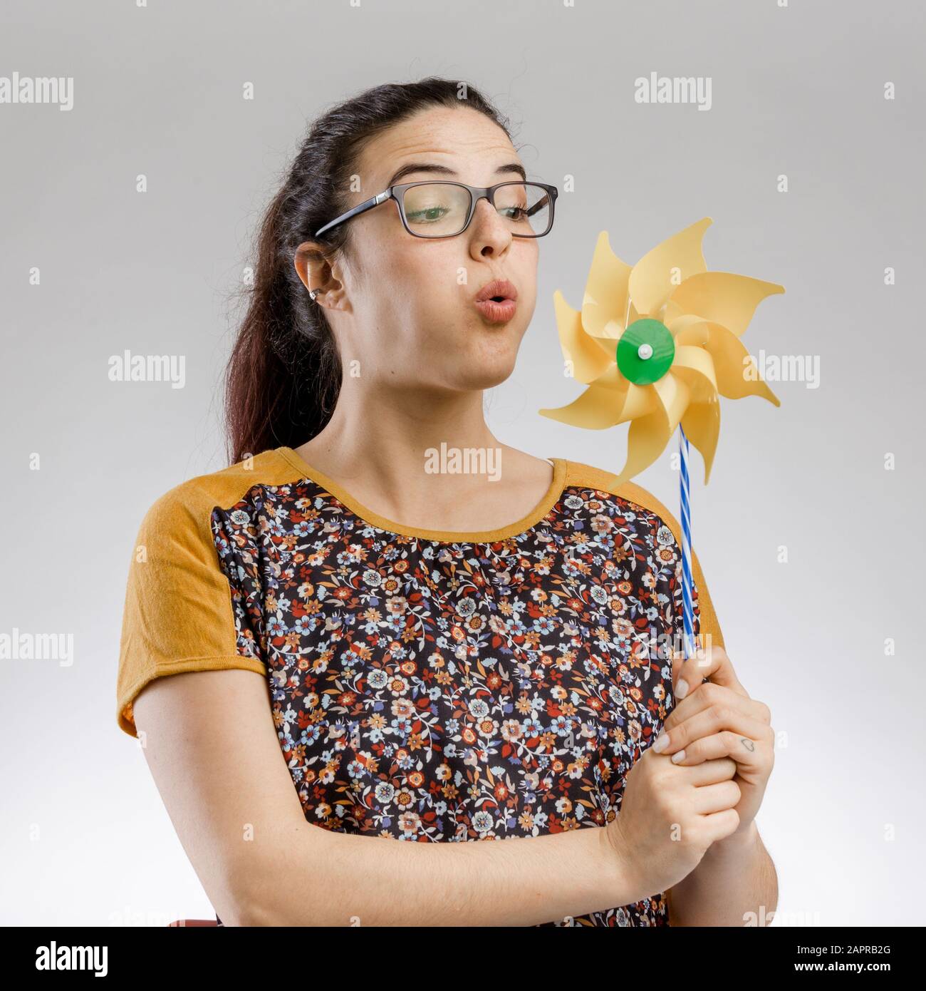 Portrait of Beautilful woman blowing a windmill Stock Photo - Alamy Portrait of Beautilful woman blowing a windmill Stock Photo - Alamy