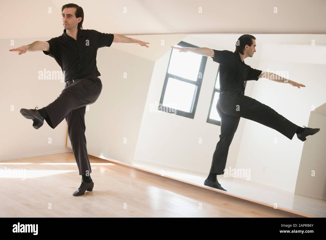 Mid adult man dancing in front of a mirror Stock Photo - Alamy