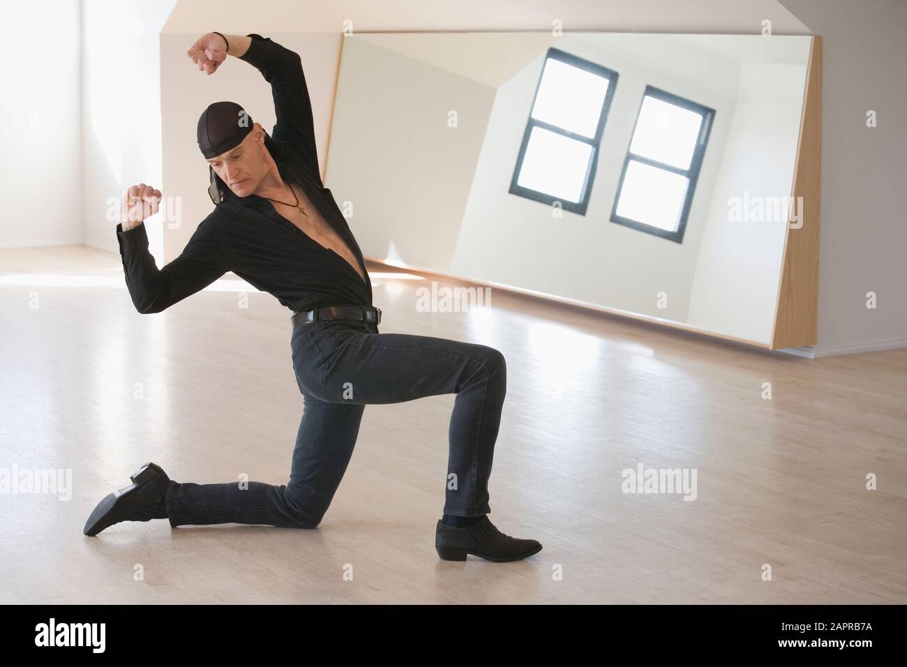 Mid adult man dancing with his arms raised Stock Photo - Alamy