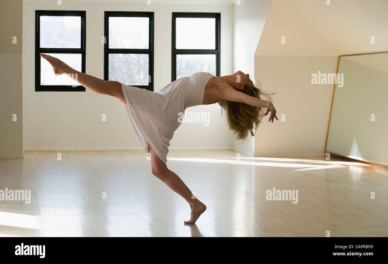 Side profile of a mid adult woman dancing Stock Photo - Alamy