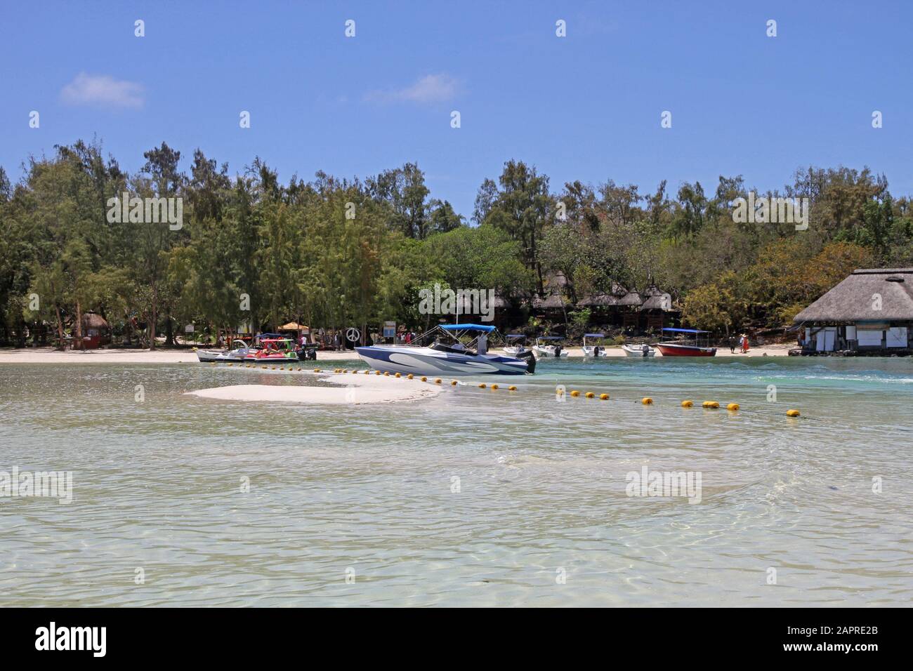 Buoy line and tour boats along beach coastline, Mauritius Stock Photo ...