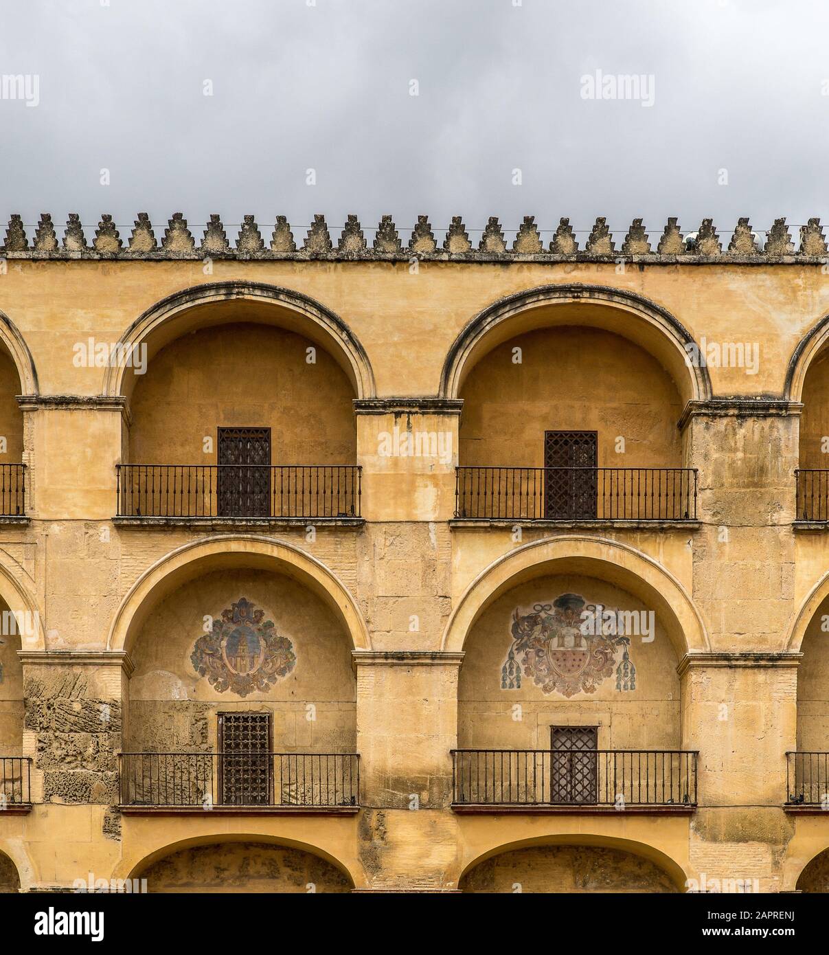 Closeup shot of the windows and arches of a coral building Stock Photo ...