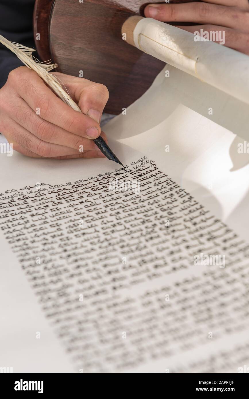 Vertical shot of a person writing with a feather on a scroll Stock ...