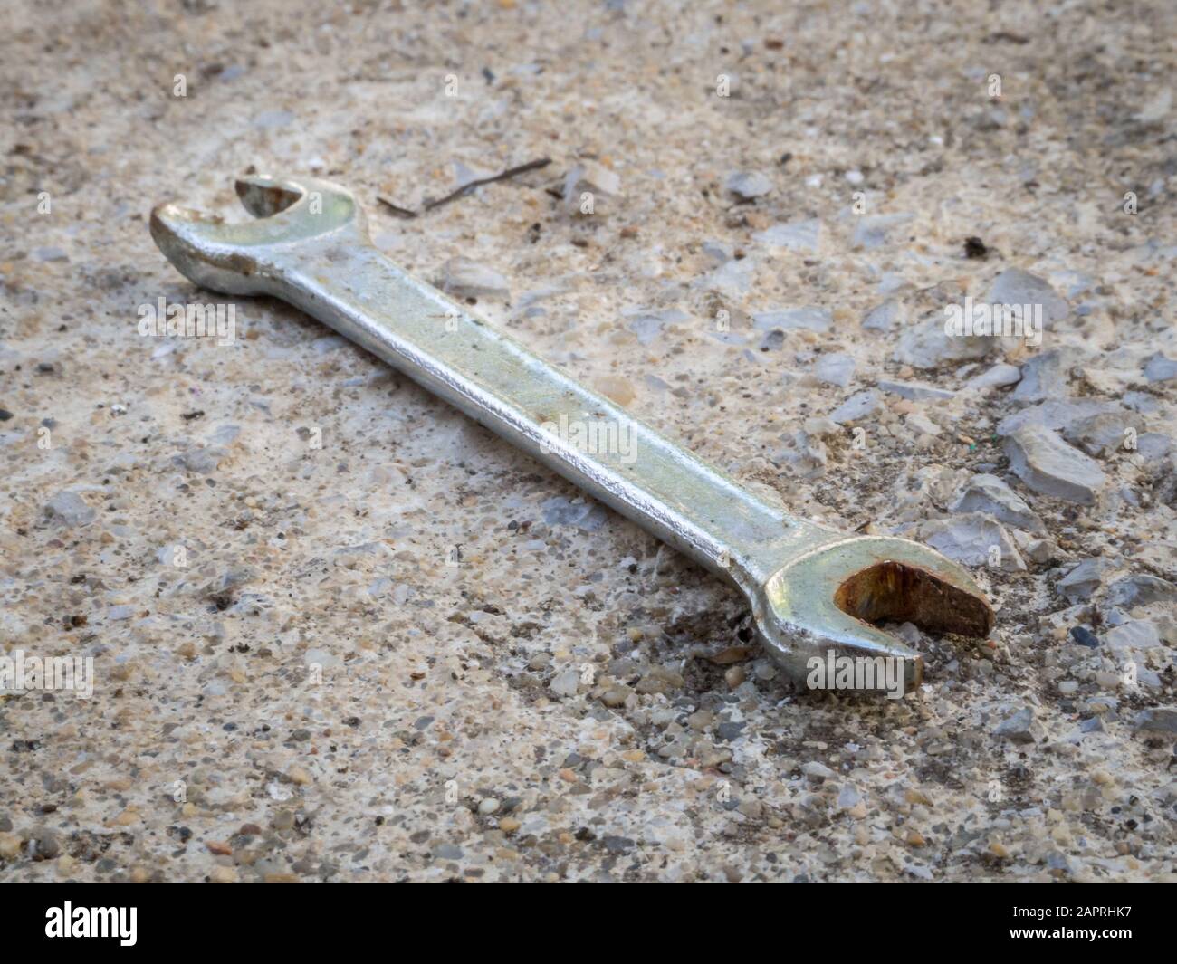 Old rusty spanner on a concrete ground during daytime Stock Photo - Alamy