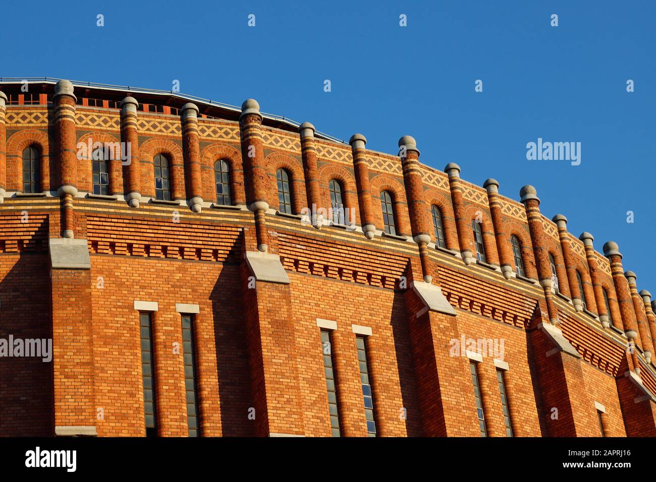 Exterior view of an old red brick gas holder building Stock Photo - Alamy