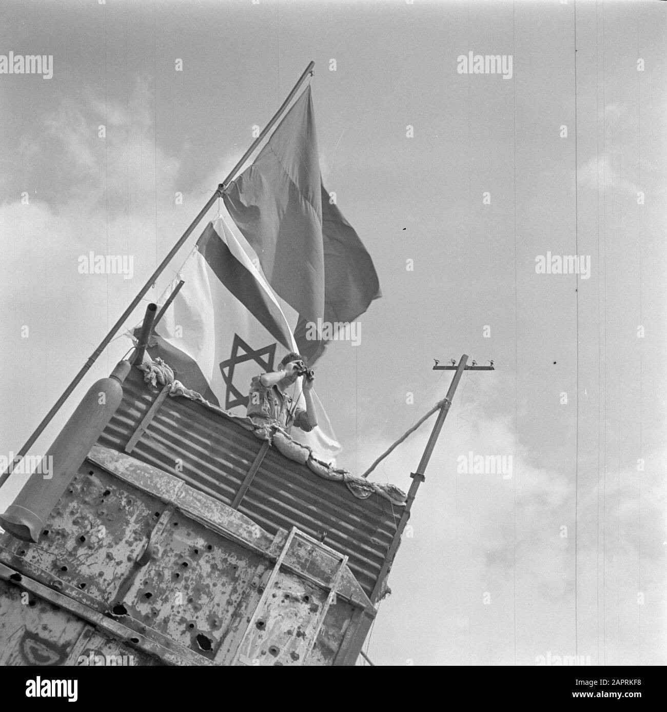 Israel 1948-1949: kibbutz Kwuzath Gezer soldier peering binoculars at a ...