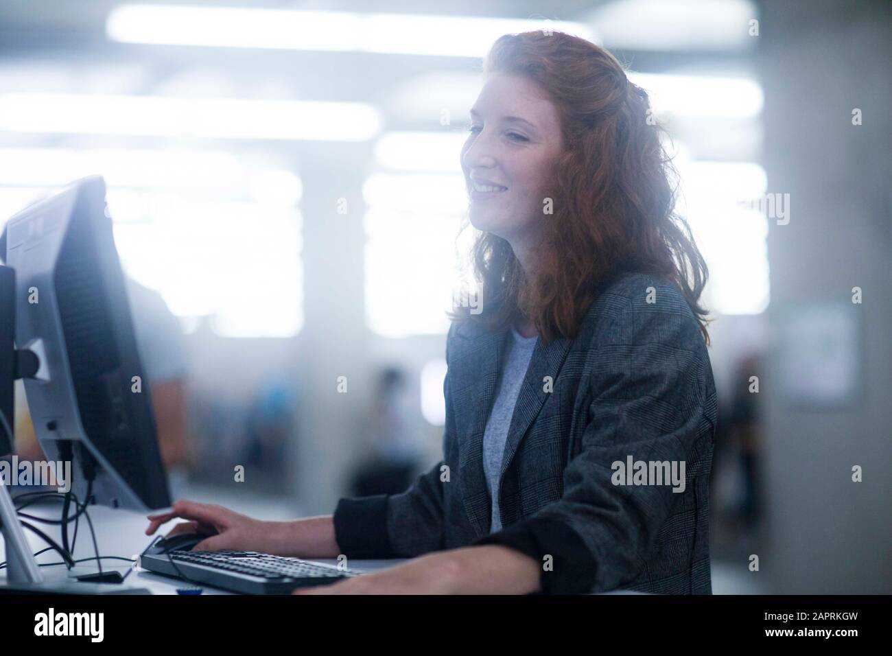 embloyee in an office smiling Stock Photo - Alamy