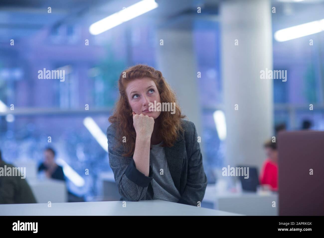 employee in an office thinking Stock Photo - Alamy