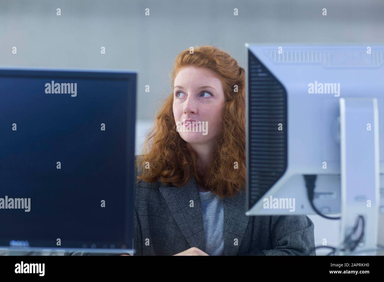 employee in an office thinking Stock Photo - Alamy