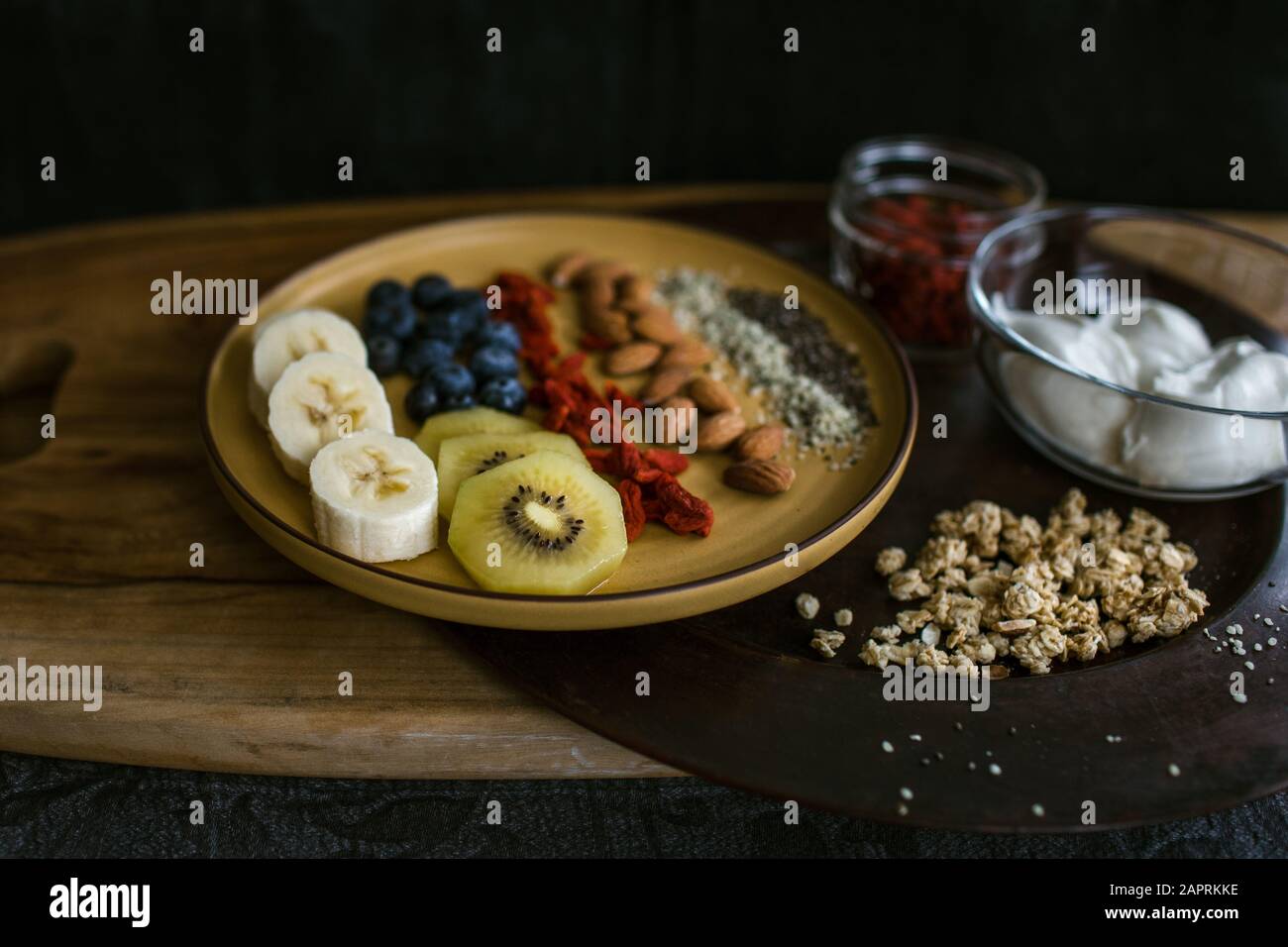 Healthy and delicious plate of fruit, nuts and seeds with yogurt and ...