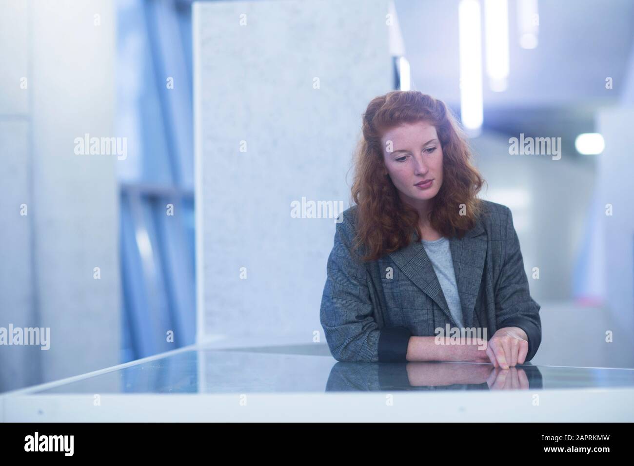 employee in an office showing to ta glass table Stock Photo - Alamy