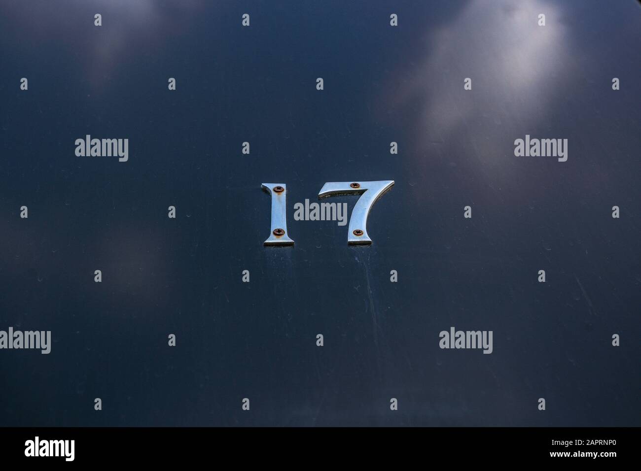 17 sign on black wall Stock Photo - Alamy
