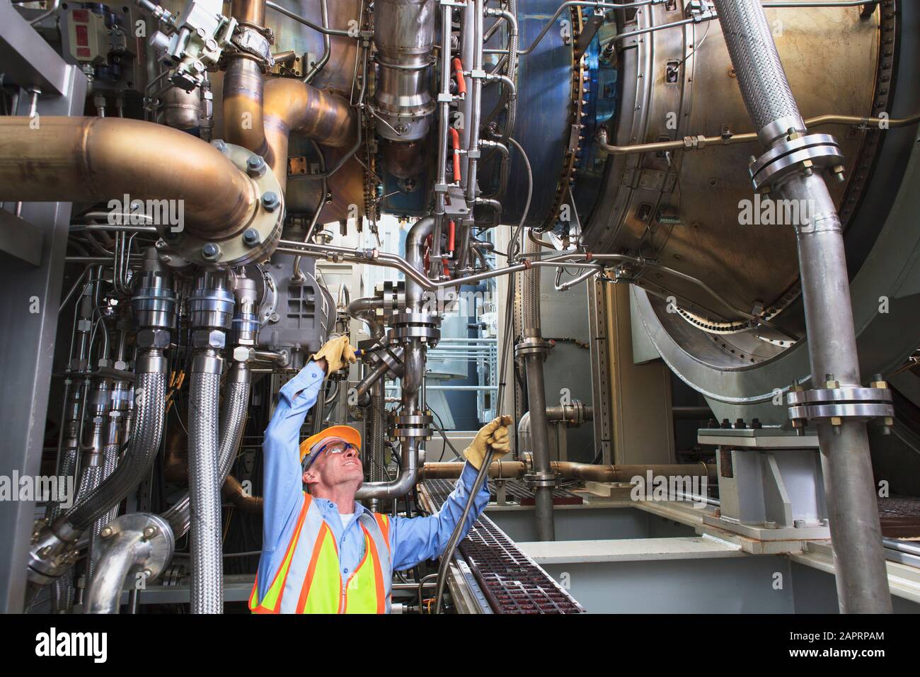 Engineer examining instrumentation cables at fuel injection stage of ...