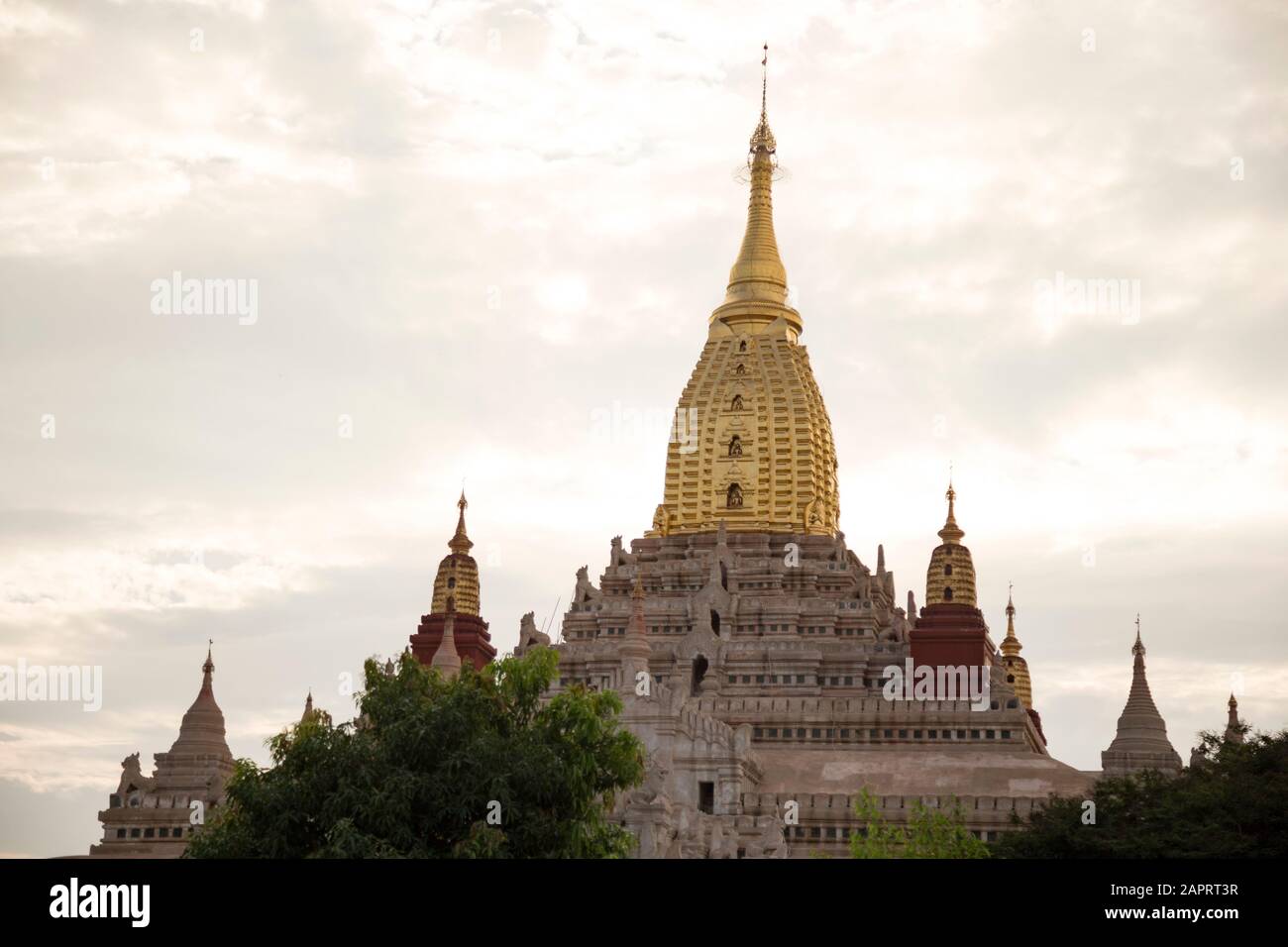 Golden tower of the Ananda Temple in Old Bagan, during golden sunset ...