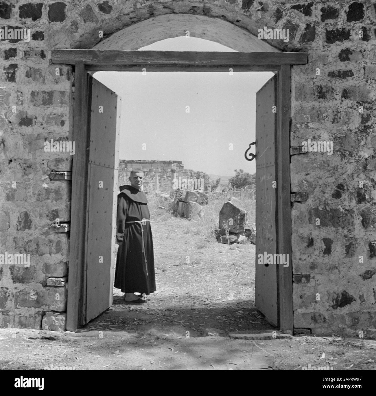 Israel 1948-1949:Galilee A Franciscan monk at an opened gate with a ...