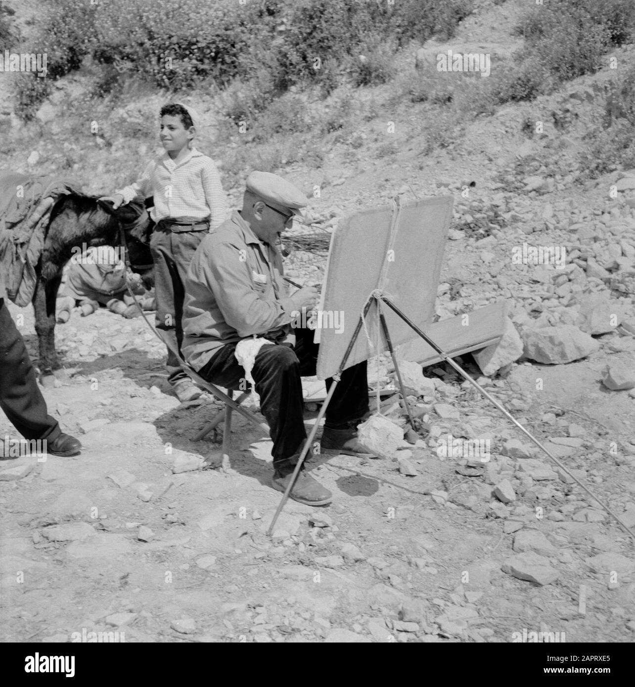 An artist at work on the street in Safad (Safed). Two little boys with ...