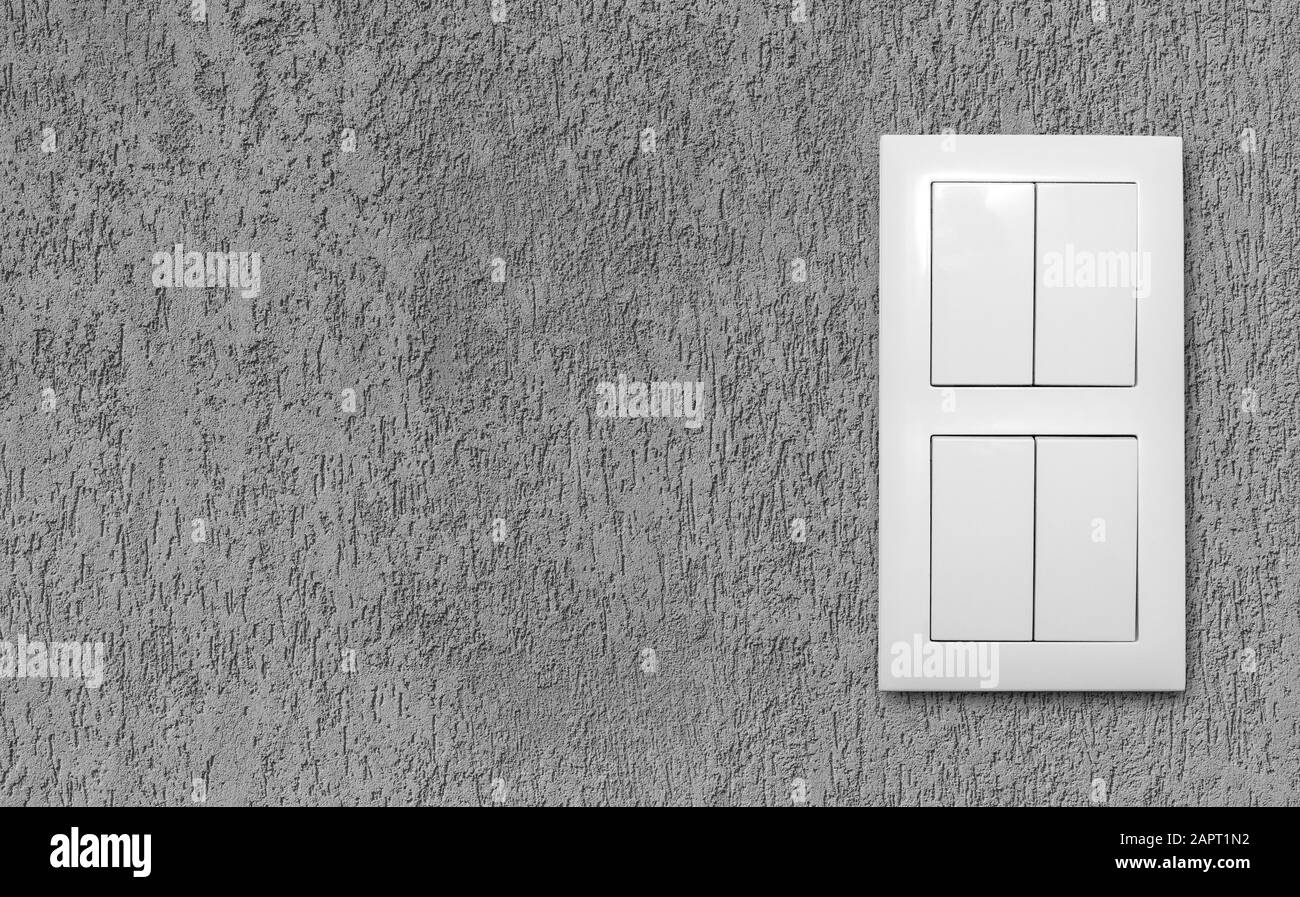 White light switches over a grey wall. Horizontal Stock Photo - Alamy
