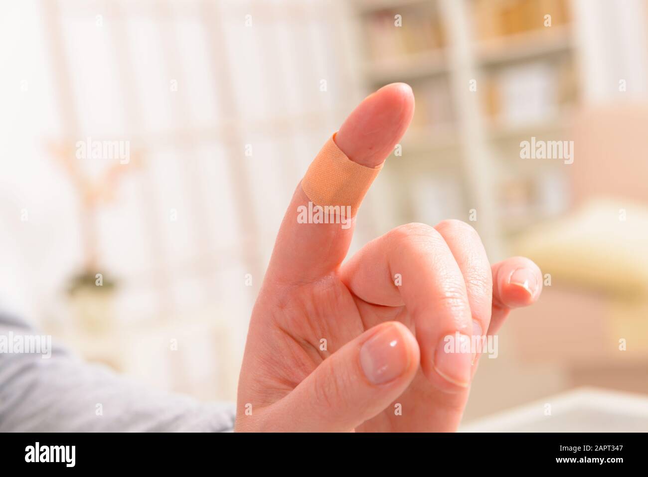 Applying adhesive bandage on bleeding finger Stock Photo - Alamy
