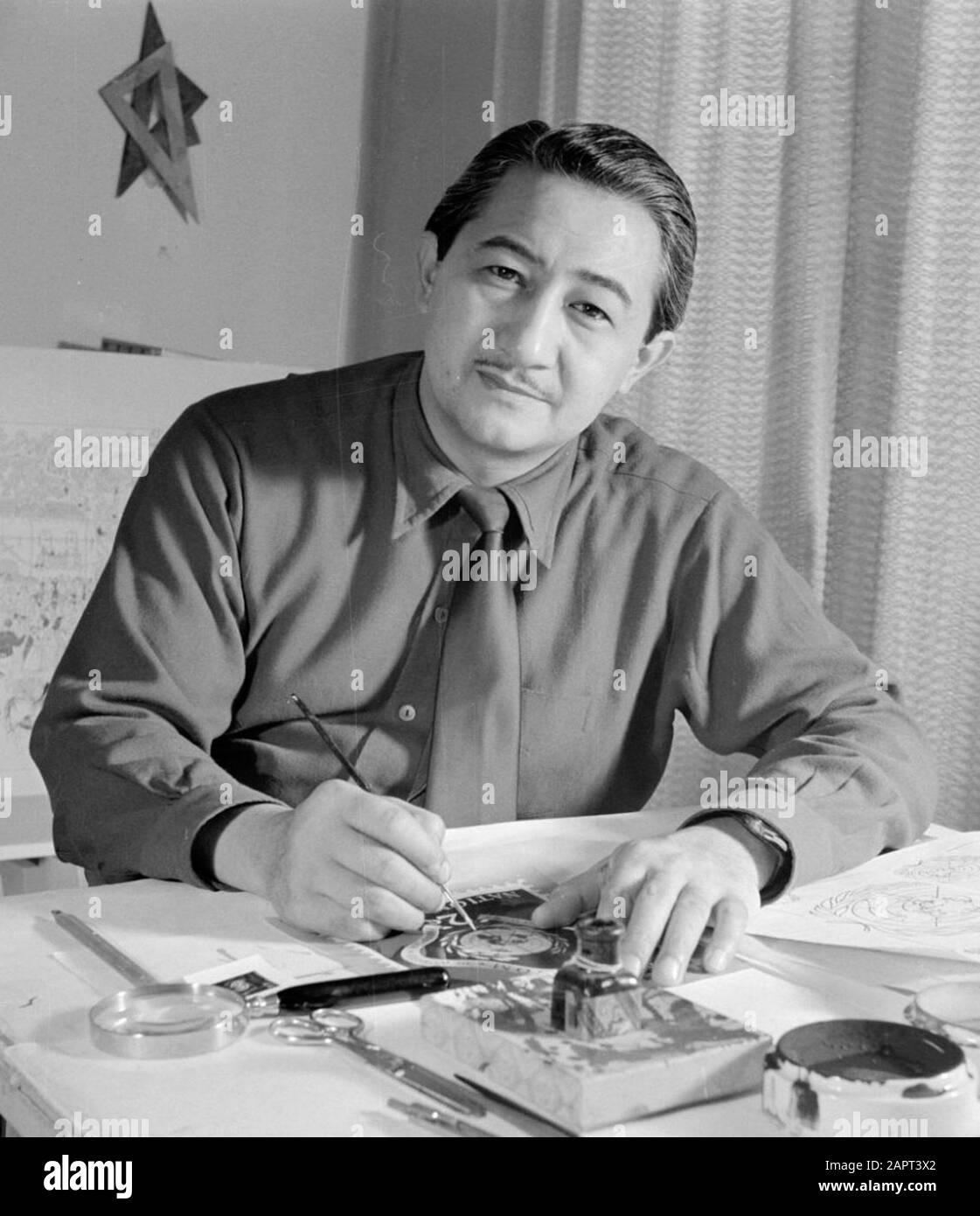 Eppo Doeve at his drawing board working on the design of the 1$ stamp ...