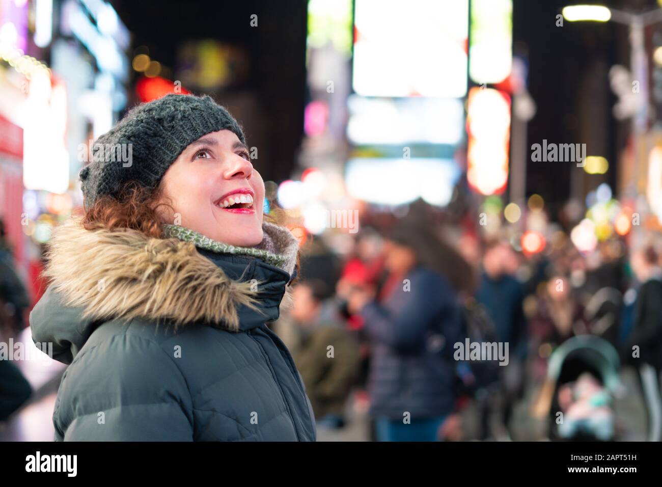 Amazed woman looking at the lights and the crowd in times square Stock ...