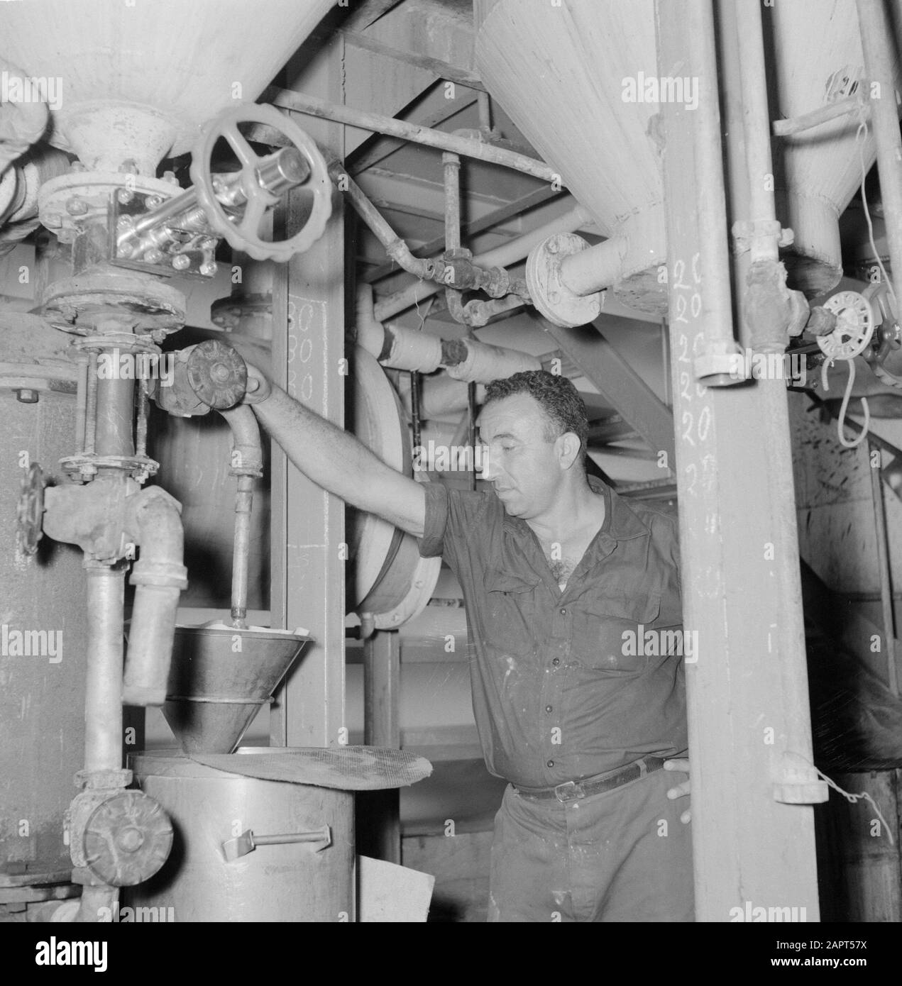 Plantex fertilizer plant near Haifa. Worker at a machine at work Date ...