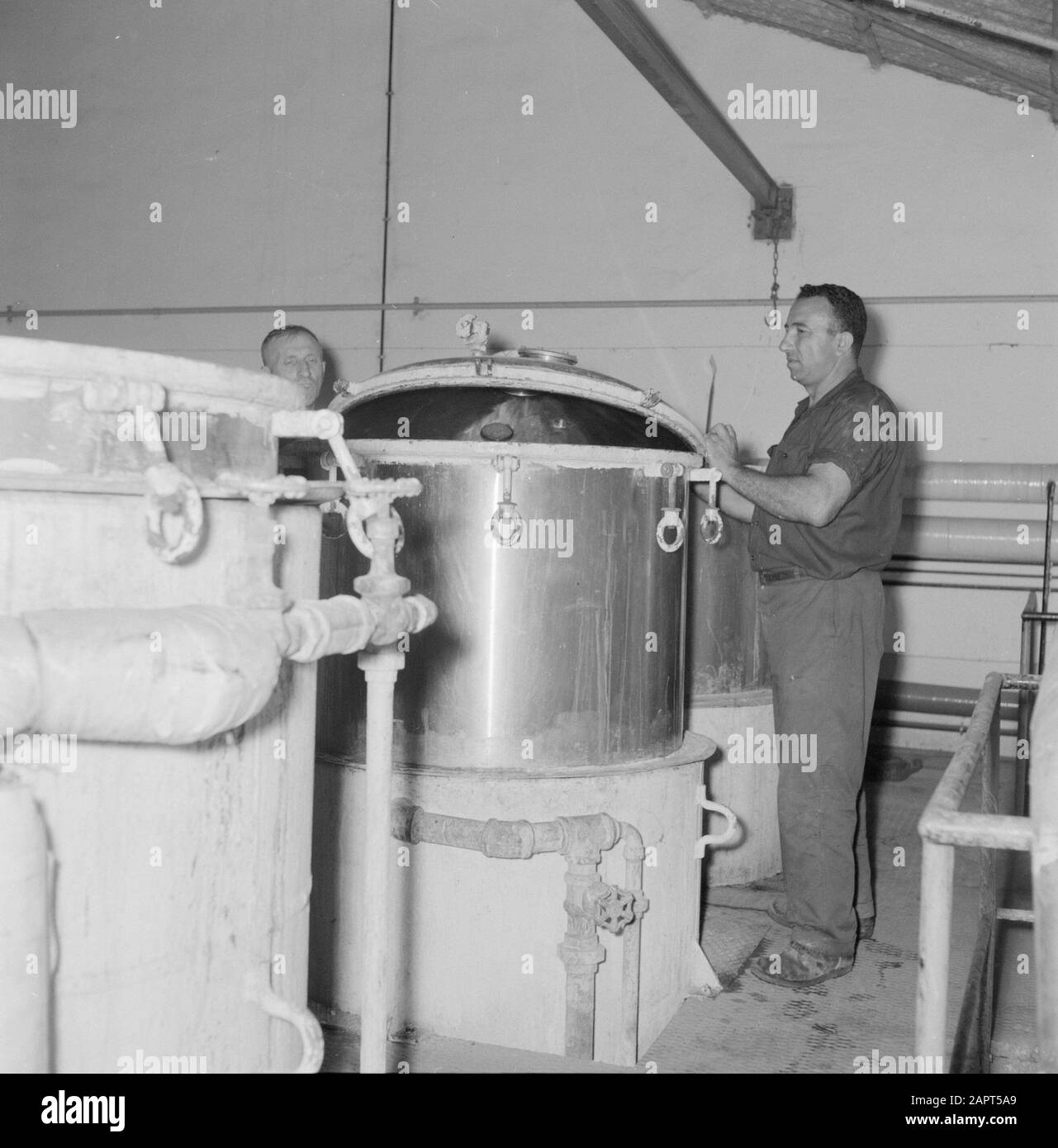 Plantex fertilizer plant near Haifa. Two men lights a lid of a boiler ...
