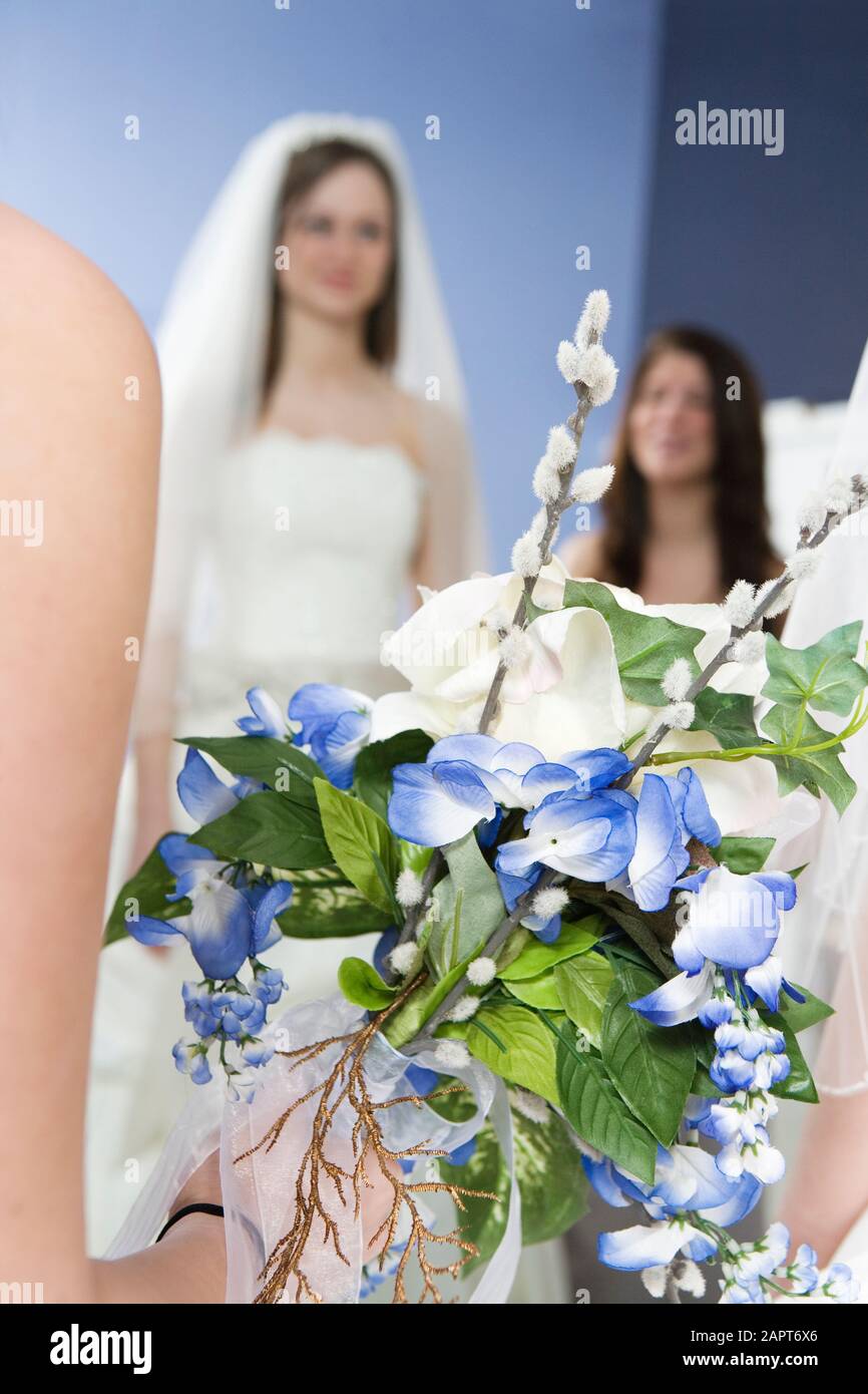 Bride with her bridesmaid looking in a mirror Stock Photo - Alamy